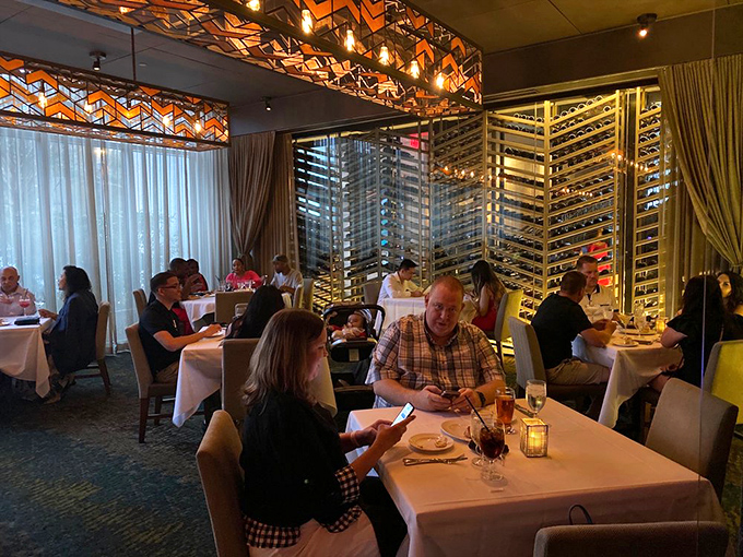Diners enjoying the Del Frisco's experience, where conversations flow as smoothly as the wine. Some memories are made between bites.