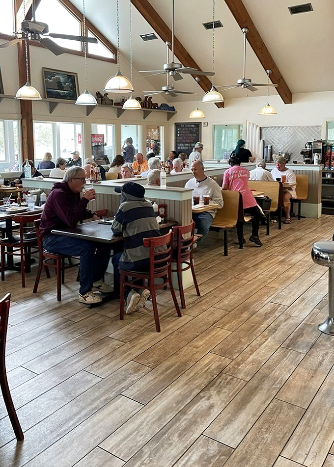 Where locals and visitors unite in the universal language of "pass the syrup" under exposed wooden beams and pendant lighting.