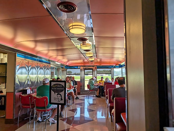 Sunlight streams through windows as diners enjoy their meals in this perfectly preserved slice of Americana, where conversation flows as freely as the coffee.
