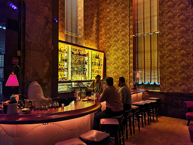 The bar glows like a treasure chest of spirits, each bottle promising its own unique story and adventure.