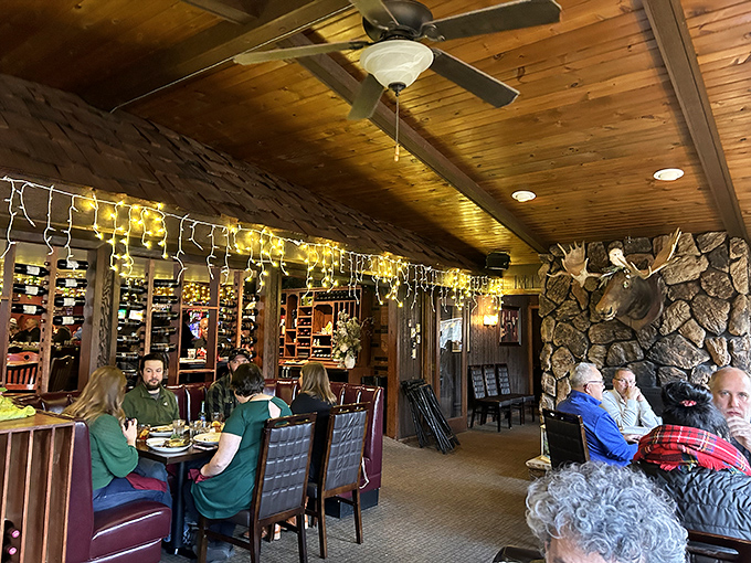 Where taxidermy meets taste&mdash;the dining room's warm wood tones and stone fireplace create that "welcome home" feeling even on your first visit.