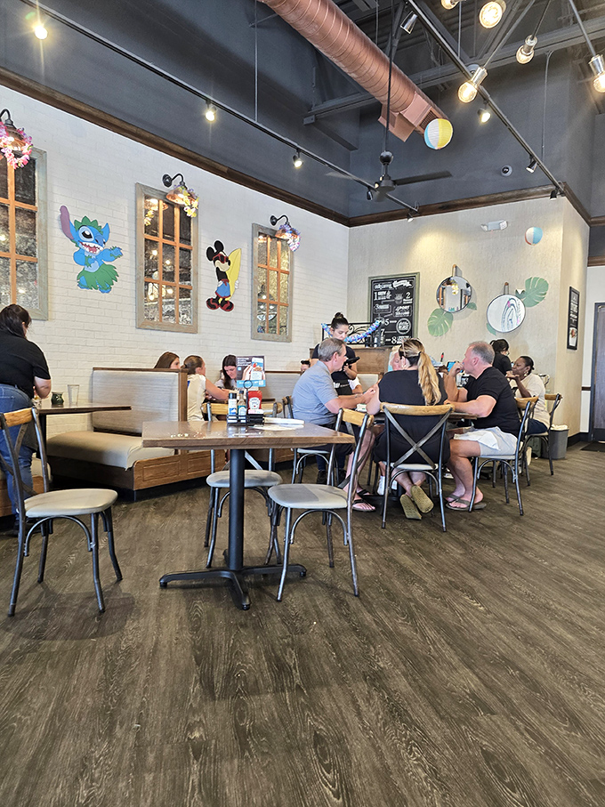 Disney characters watch over diners like breakfast guardian angels. Mickey seems particularly impressed with everyone's omelet choices.