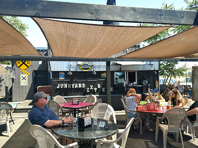 The outdoor seating area offers a shaded retreat where Junction City locals and visitors alike gather to tackle burgers of legendary proportions.