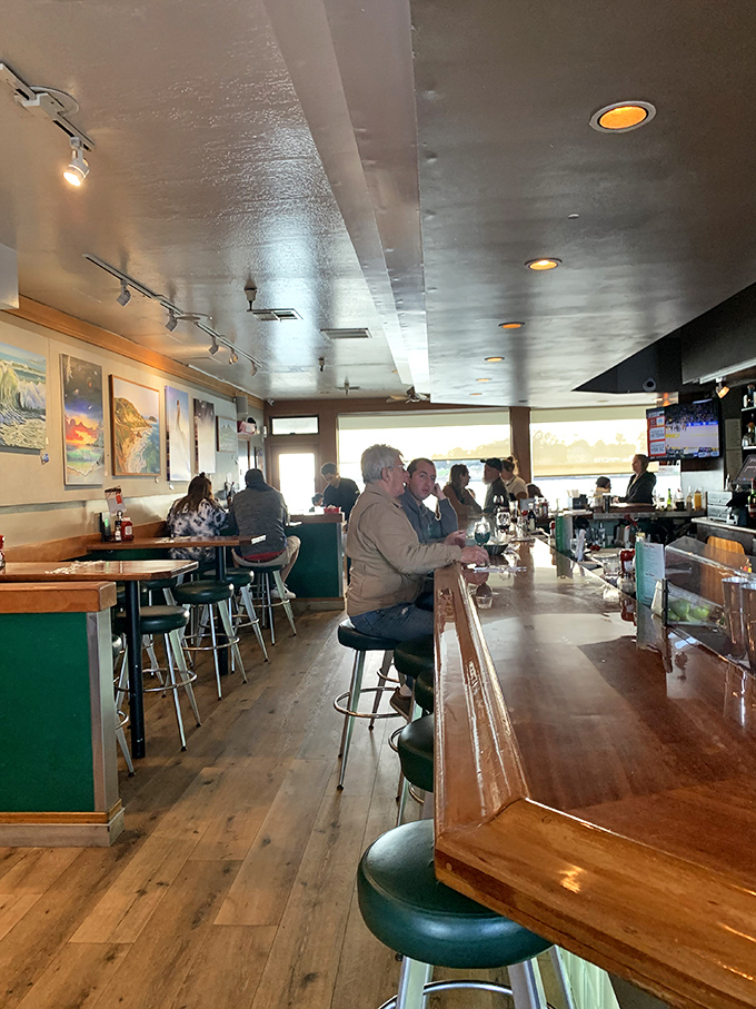 Where strangers become temporary friends at the bar, united by good drinks and the hypnotic rhythm of waves visible through the windows.