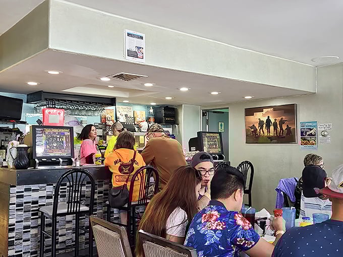 A bustling morning at Stuff's, where conversations flow as freely as the coffee. The counter seats offer front-row views of breakfast theater.