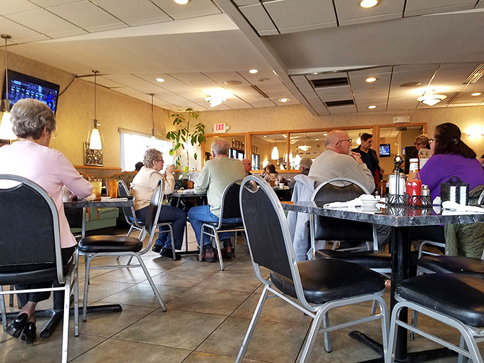 Where strangers share countertops and coffee refills flow like conversation. The rhythmic clink of silverware creates the soundtrack of satisfaction.