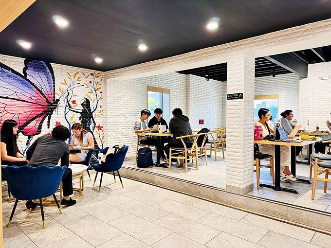 A butterfly mural watches over diners enjoying their treats. Even the walls know you're about to have a transformative eating experience.