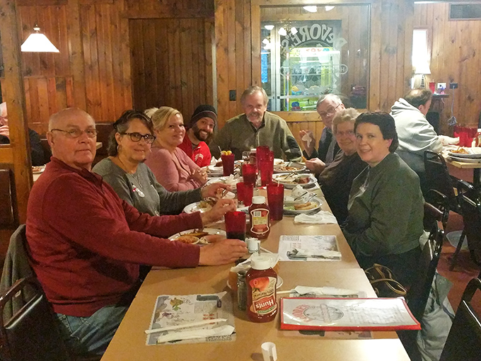 The universal language of contentment: folks gathered around tables, sharing good food and better stories.