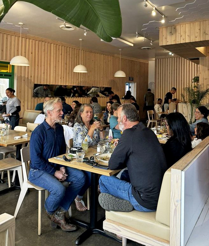 The weekend crowd at Madi proves that great food creates community—strangers united by the universal language of "have you tried the pancakes?"