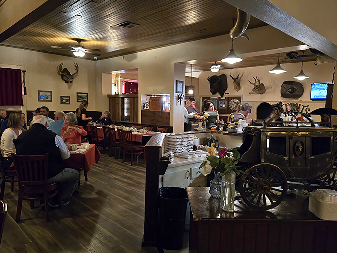 The Western-themed dining room balances rustic charm with comfortable elegance—taxidermy meets tablecloths in a space where memories are made between bites.