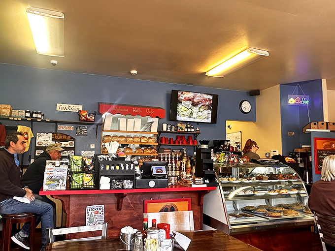 Behind the counter, where the magic happens. Blue walls and red accents create that classic American diner vibe that never goes out of style.