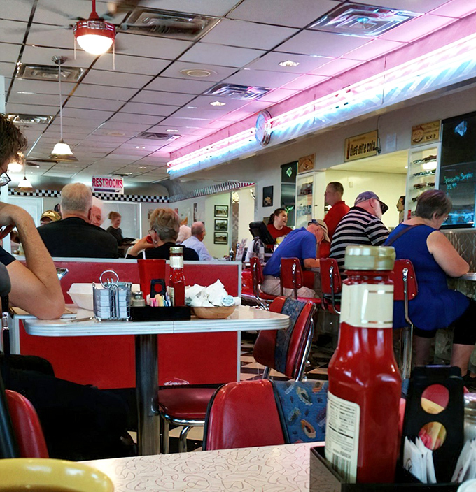 The diner buzzes with the energy of regulars and travelers alike, all drawn to this temple of comfort food where conversations flow as freely as the coffee.