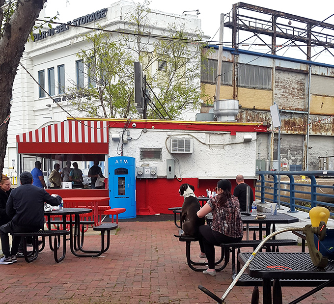 The outdoor seating area transforms lunch into community theater, where strangers become friends over shared sandwich appreciation.