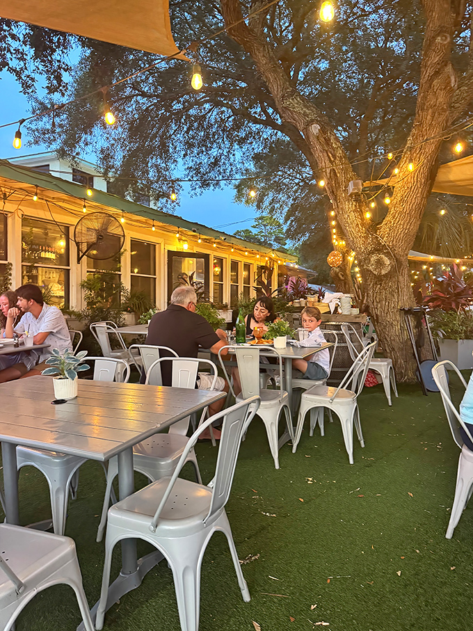 Evening patio dining under twinkling lights transforms a simple meal into a magical coastal memory you'll treasure forever.