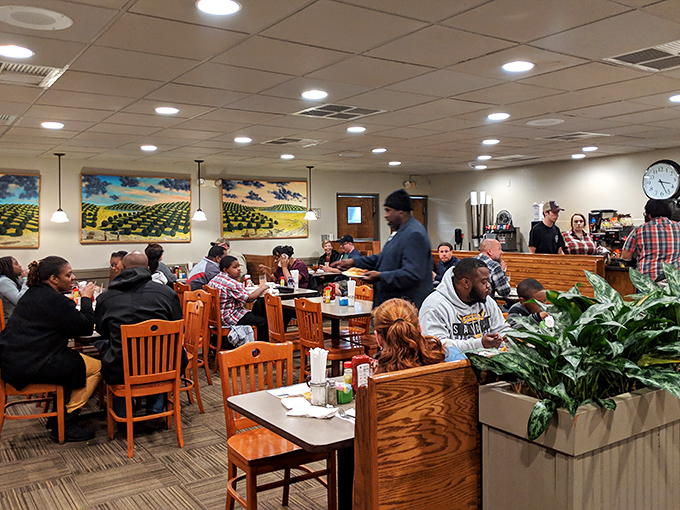 A bustling dining room where strangers become temporary friends united by the universal language of "have you tried the fried chicken yet?"