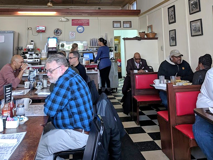 The morning symphony of forks against plates and coffee cups clinking. These aren't just diners—they're breakfast enthusiasts on their daily pilgrimage.
