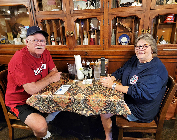 Happy diners enjoying that magical moment when conversation pauses because the food demands complete attention.
