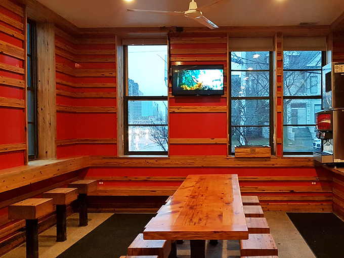 Minimalist seating that says, "We know why you're here, and it's not for the furniture." Red walls warm the space like a smoker's embrace.