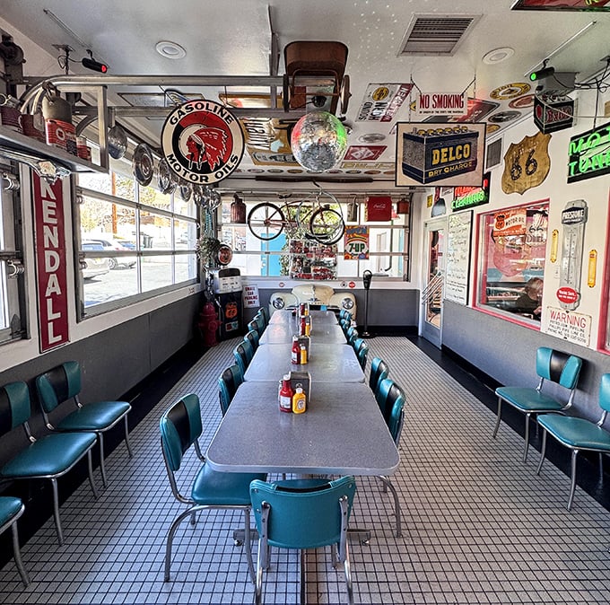 The community table where memories are made between bites, surrounded by enough vintage memorabilia to fill a museum.