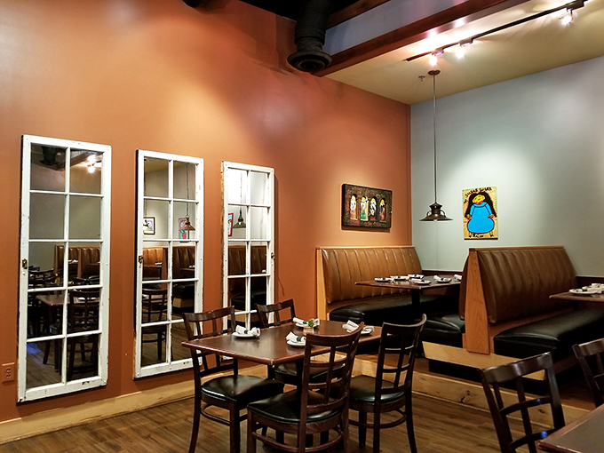 Terracotta walls and vintage window panes create dining nooks that feel like you've stumbled into someone's stylish Southern home.