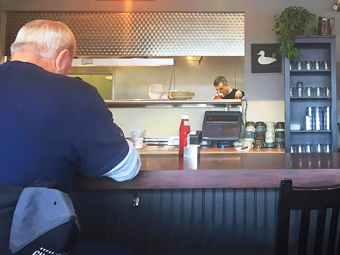 The counter seats offer front-row tickets to the culinary performance. Sometimes the best entertainment comes with breakfast.