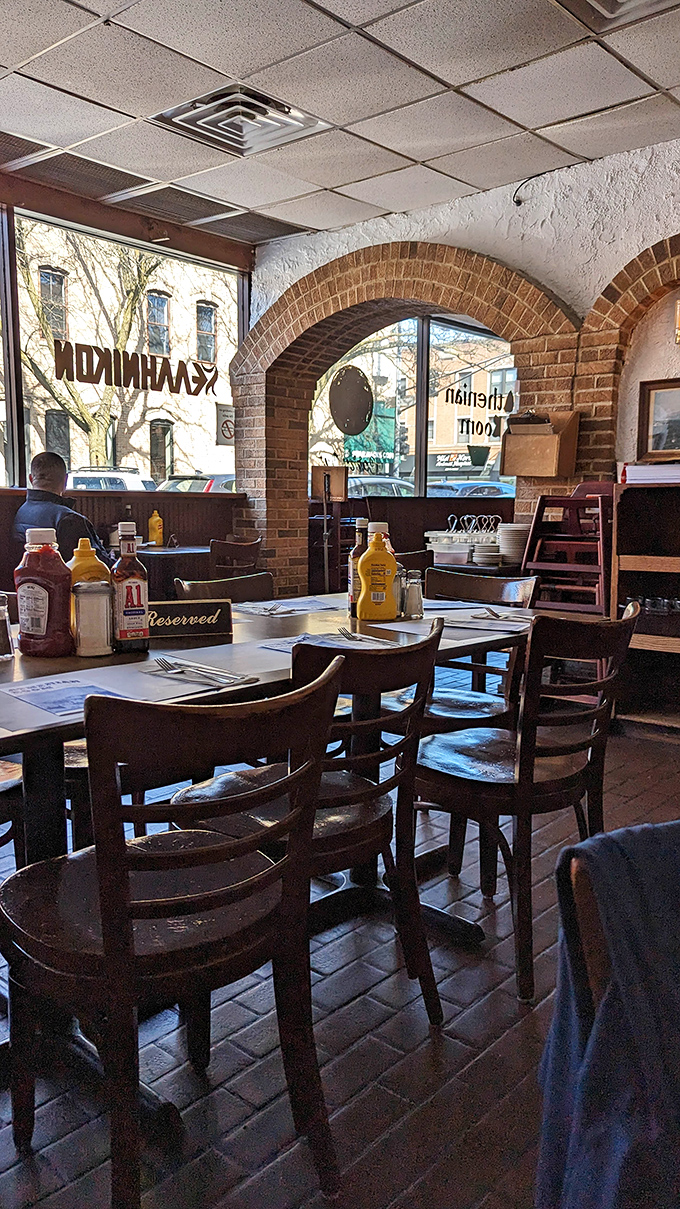 Morning light streams through the brick arches, transforming this humble eatery into a warm, inviting sanctuary for hungry souls.