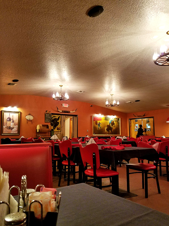 Red booths, wooden chairs, and warm lighting create that classic steakhouse ambiance where calories don't count and diet plans go to die.