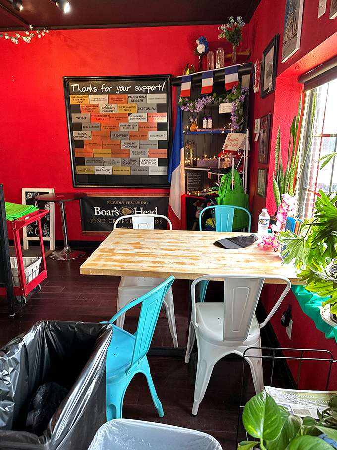 The dining area's vibrant red walls and French flag create the perfect setting for your carb-induced euphoria. Those metal chairs have witnessed countless food revelations.