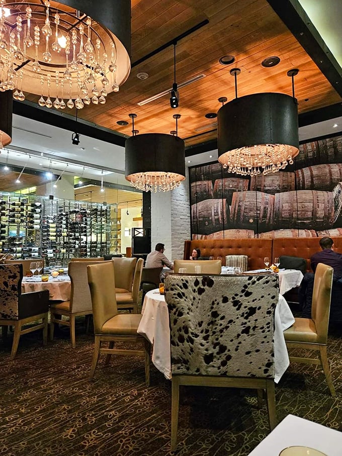 Wine barrels adorn the walls while crystal chandeliers dangle overhead &ndash; rustic meets refined in this thoughtfully designed dining space.