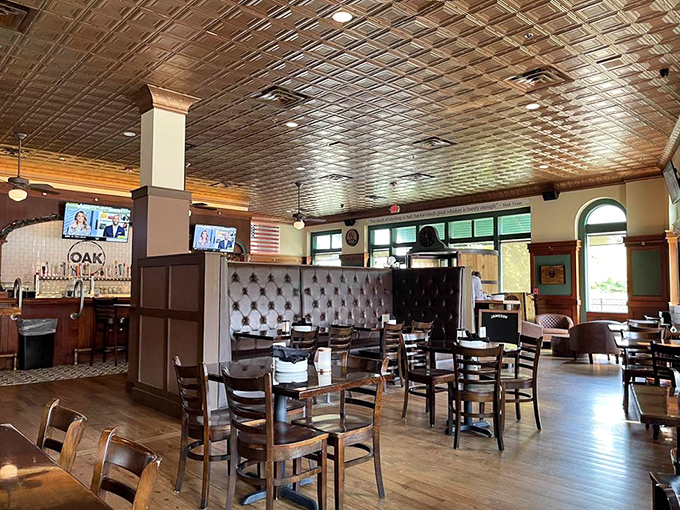 The thoughtful layout creates distinct dining zones with leather banquettes and wooden accents that somehow feel both upscale and completely comfortable.