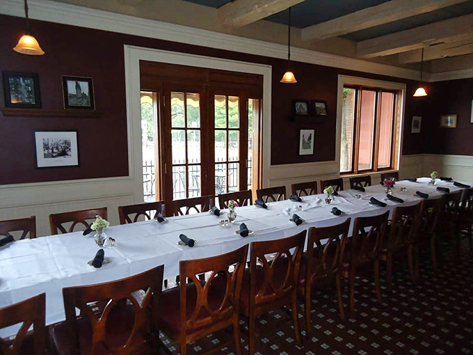 The private dining room stands ready for celebration, where white tablecloths and wooden chairs await memory-making moments.