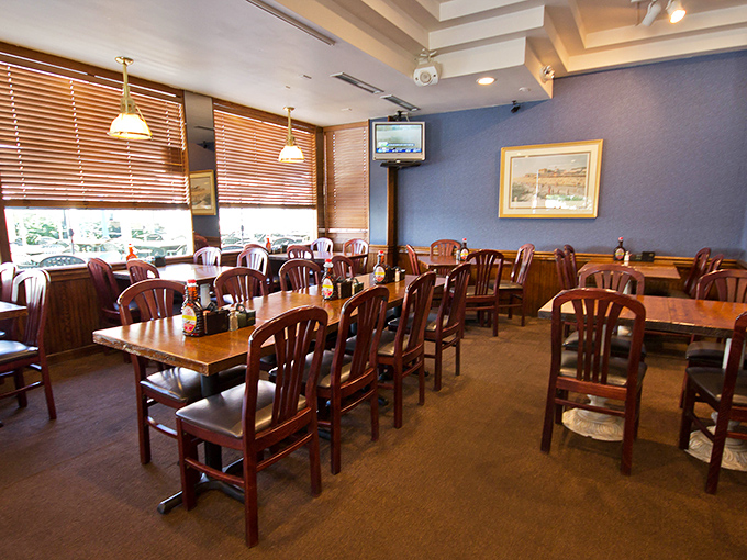 The dining room waits patiently for the breakfast rush, like a theater before the show. Those wooden chairs have heard countless vacation stories.