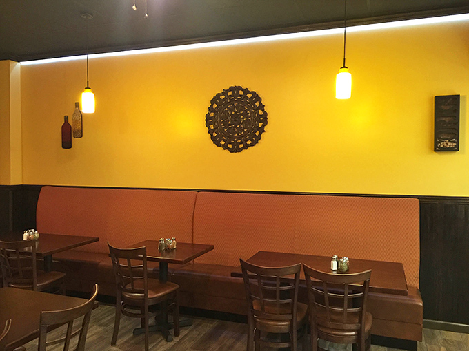 The orange banquette seating practically hugs you while you eat. Casual comfort that invites you to stay for "just one more slice."