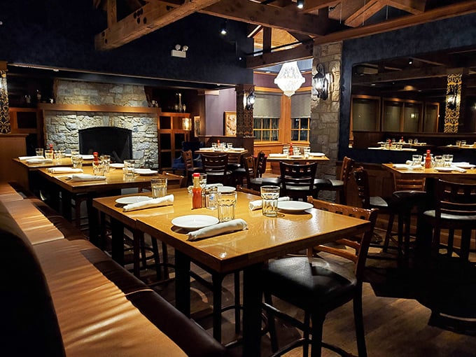 Stone fireplace, wooden tables, and comfortable seating&mdash;this dining area feels like the living room of that friend who really knows how to cook.