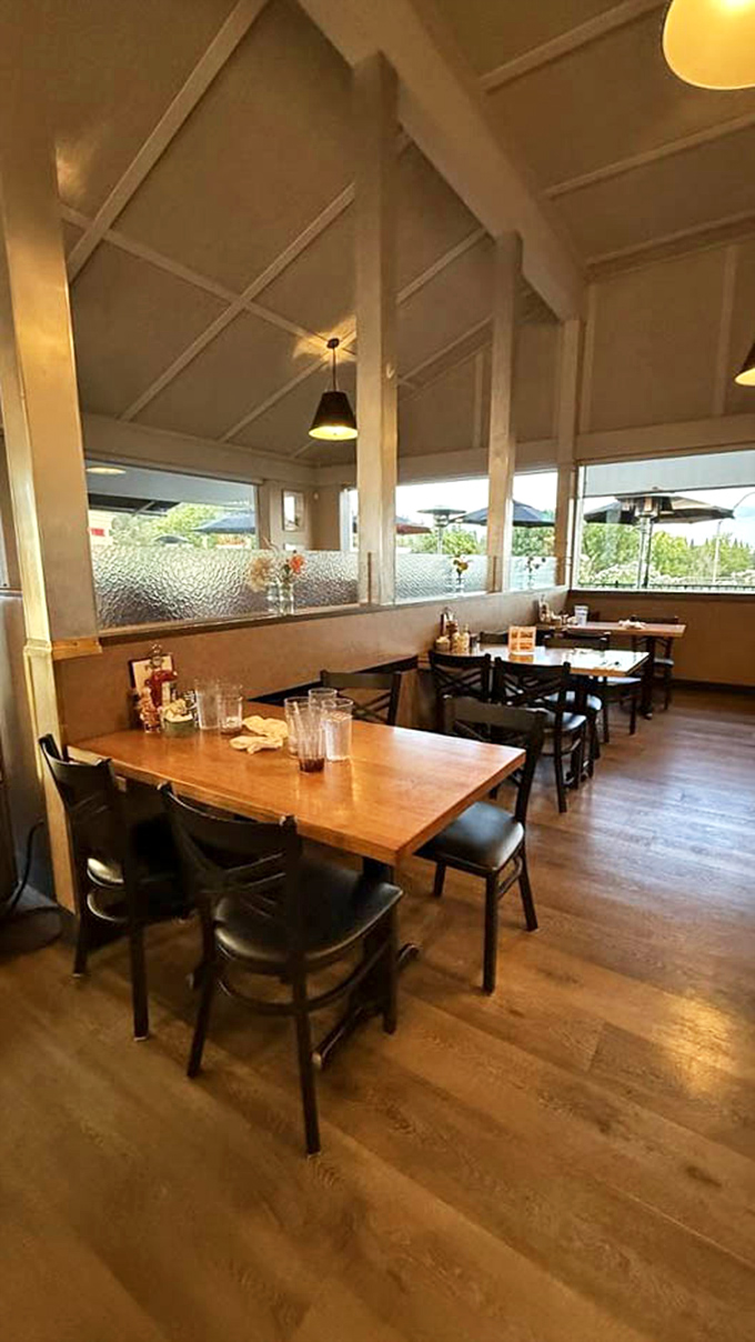 Wooden tables, comfortable seating, and those pendant lights creating the warm glow that makes every meal feel like a special occasion.