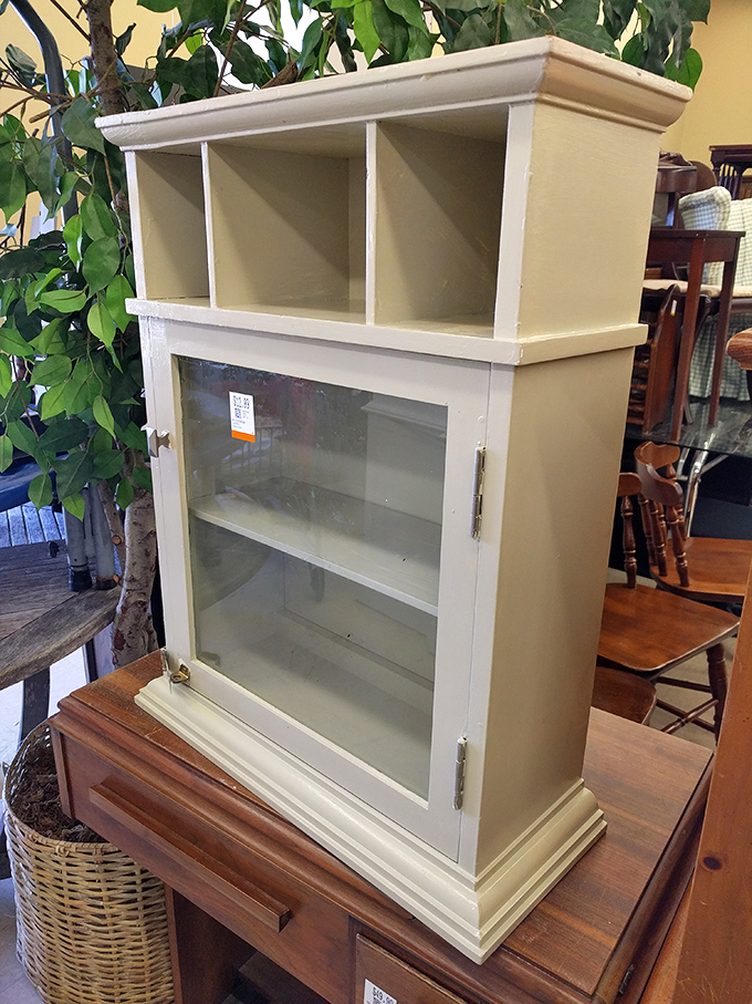 A petite display cabinet that's probably held everything from wedding china to action figure collections in its previous lives.
