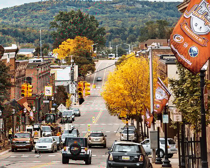 Fall paints Marquette's streets with golden maples, while local banners celebrate the town's identity as both a college community and outdoor paradise.