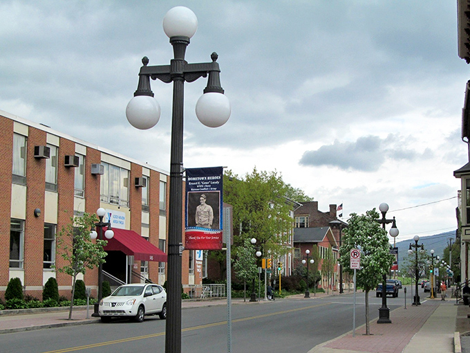 Vintage lampposts and brick buildings create a downtown straight from a Hallmark movie. Norman Rockwell would have set up his easel right here.
