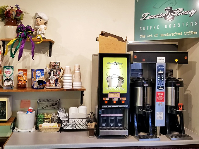 The coffee station stands ready to provide the perfect bitter counterpoint to sweet treats. In the bakery universe, this corner is essential infrastructure.