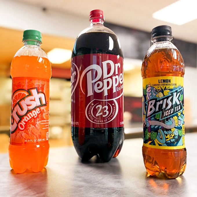 The holy trinity of fountain drinks stands ready to wash down your pizza feast. Orange Crush, Dr. Pepper, and Brisk &ndash; the perfect pizza companions.