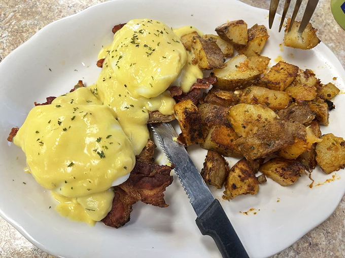 Eggs Benedict that's nailed the hollandaise-to-egg ratio. That sauce is sunshine-yellow perfection, cascading over those English muffins like a dream.