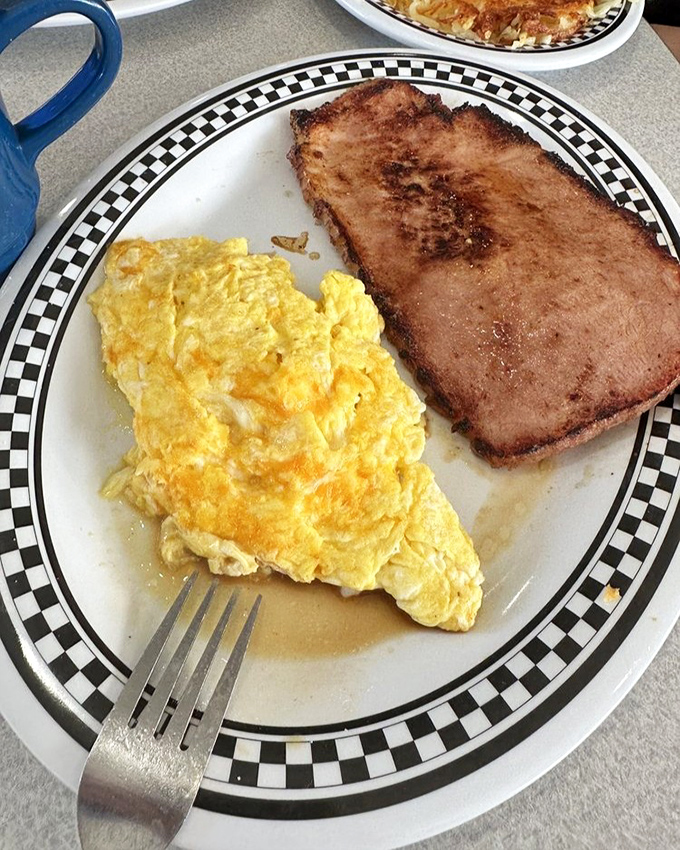 The classic breakfast duo &ndash; fluffy scrambled eggs alongside ham with just the right amount of caramelization on its edges.