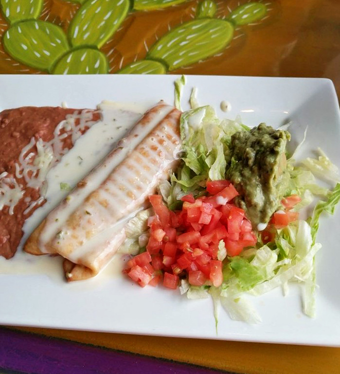 A perfect plate of enchiladas with all the fixings &ndash; the comfort food equivalent of a warm Mexican hug.