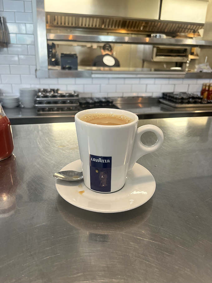 Not just coffee&mdash;a proper espresso that would make an Italian nod in approval. The kitchen view reminds you this is serious breakfast business.