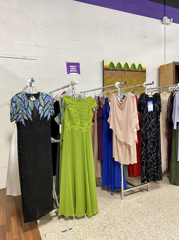 Formal dresses in lime green and midnight sequins hang like abandoned prom dreams, waiting for their second chance at a grand entrance.