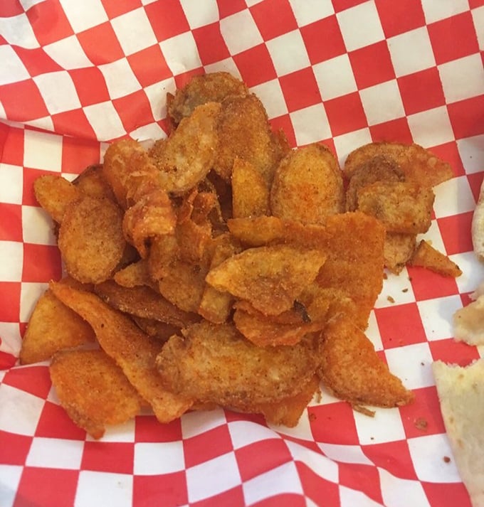 Crispy, golden flat fries that crackle with each bite. The checkered paper is practically a warning: "Prepare to get happily messy."