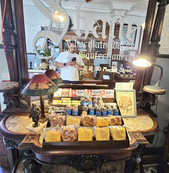 Sweet treasures displayed like museum artifacts. This confectionery case would make Willy Wonka himself stop and take notes.