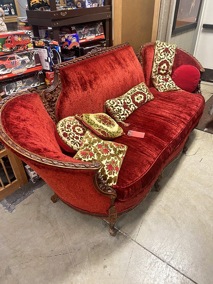 A crimson velvet settee fit for Marie Antoinette or your eccentric aunt who insists on being called "Madame" and drinks tea with her pinky extended.
