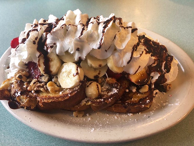 French toast that's having an identity crisis as a dessert&mdash;and we're not complaining. Whipped cream, bananas, and chocolate drizzle turn breakfast into celebration.