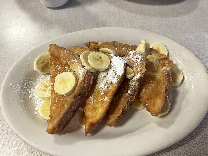 French toast that doesn't need a passport to transport you to breakfast heaven, topped with bananas that didn't sacrifice themselves in vain.